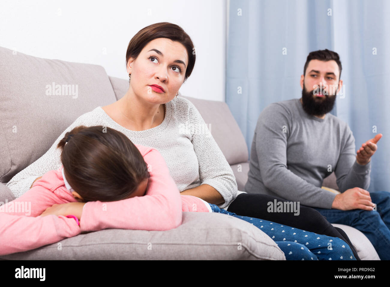 Father telling off his wife and daughter for disobedience at home Stock ...