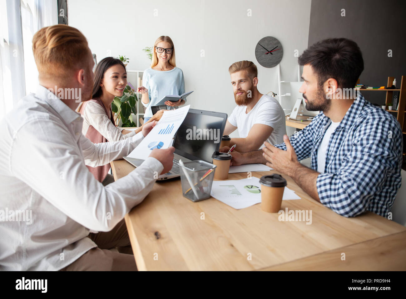 Young team of coworkers making great business discussion in modern ...