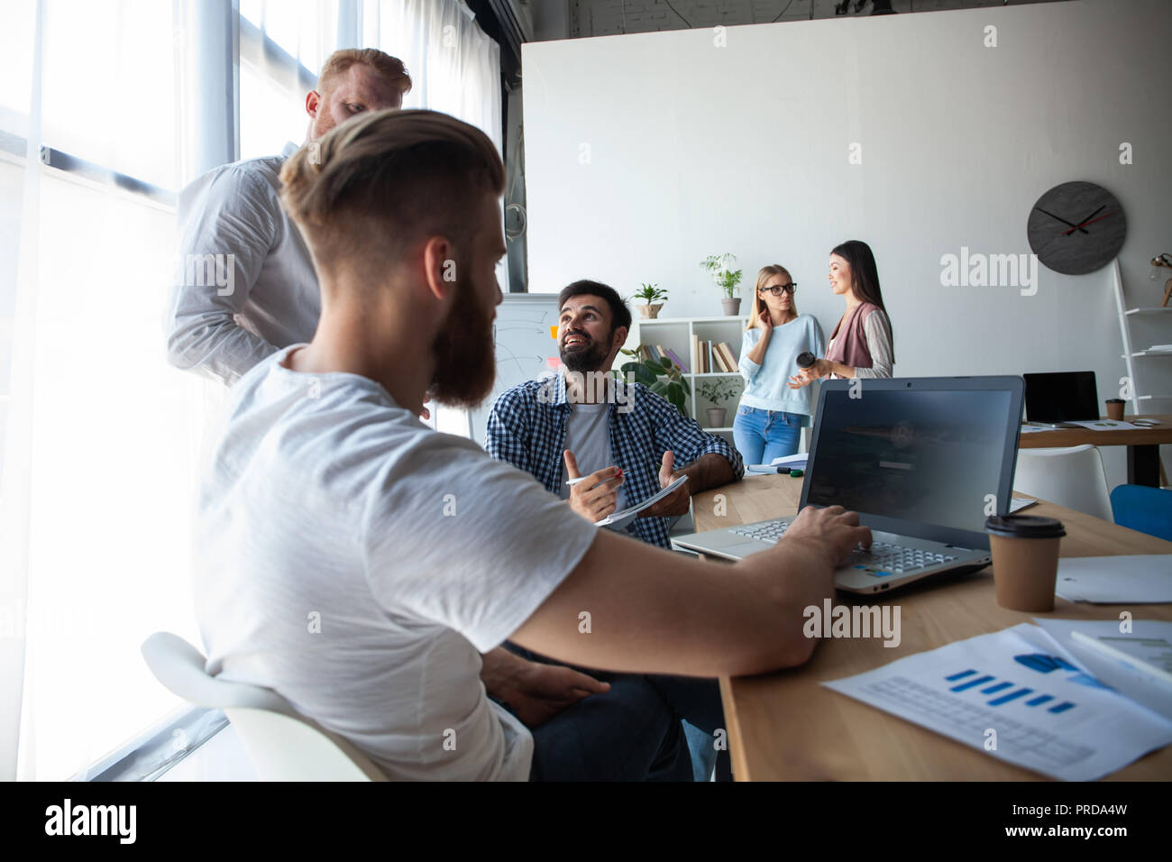 Creative office. Young modern colleagues in smart casual wear working ...