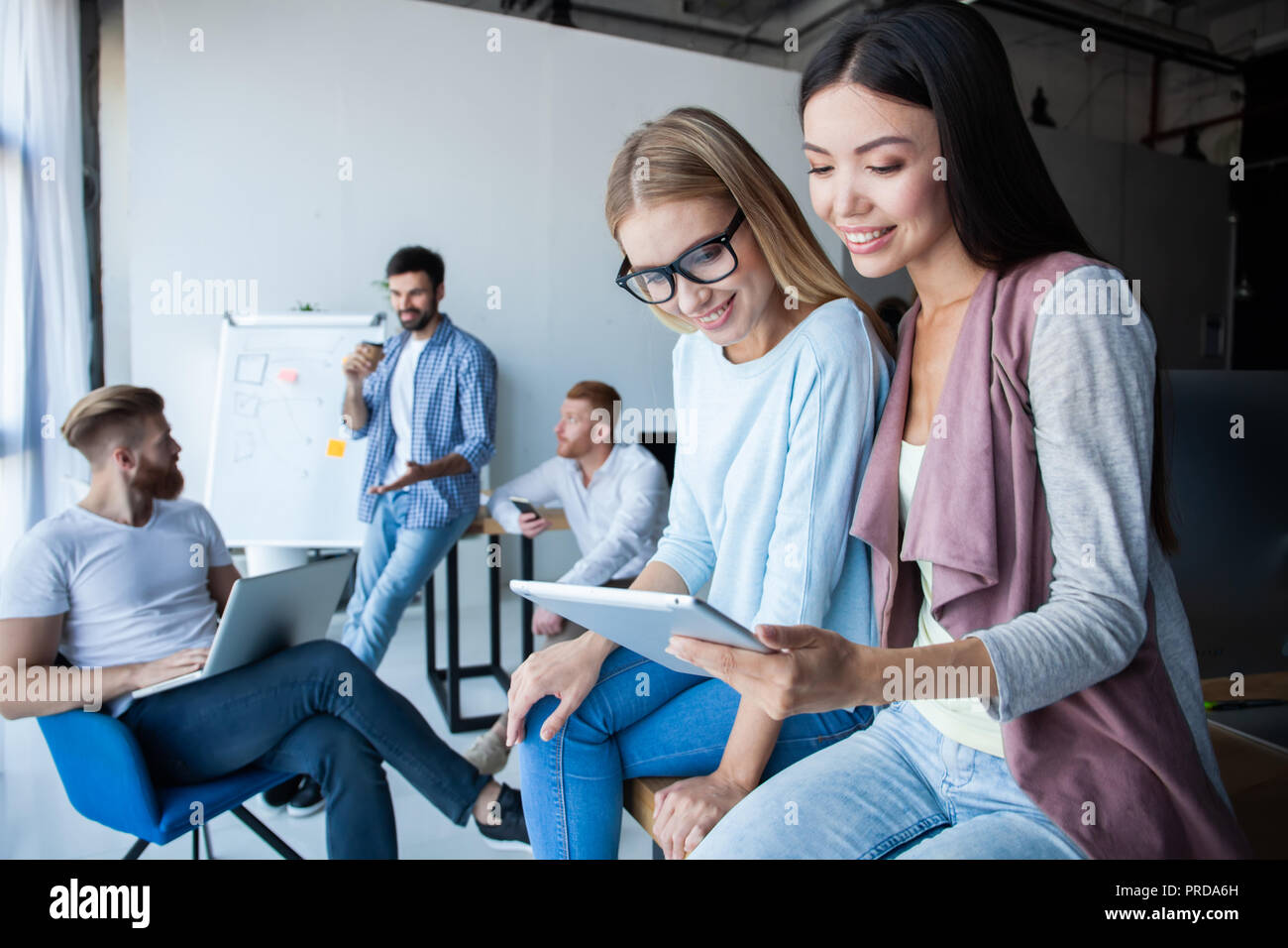 Office life. Group of young business people working and communicating ...