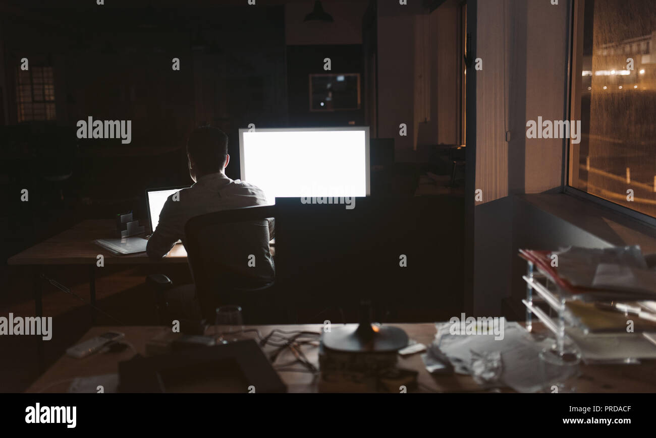 Dark office worker at computer hi-res stock photography and images - Alamy