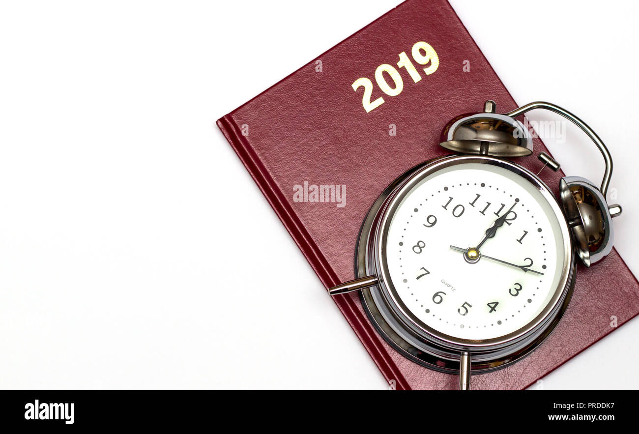 alarm clock and diary on a white background Stock Photo - Alamy