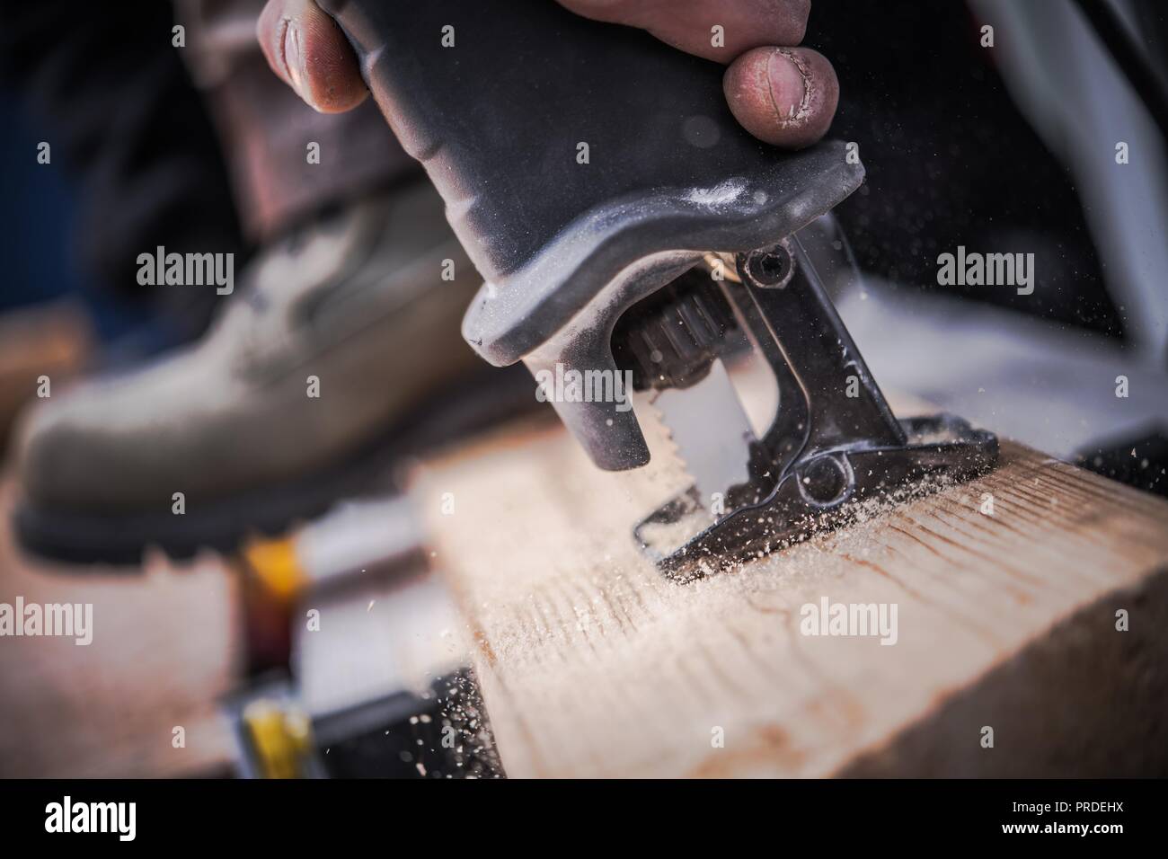 Reciprocating Saw Woodwork Closeup Photo. Caucasian Contractor Cutting ...