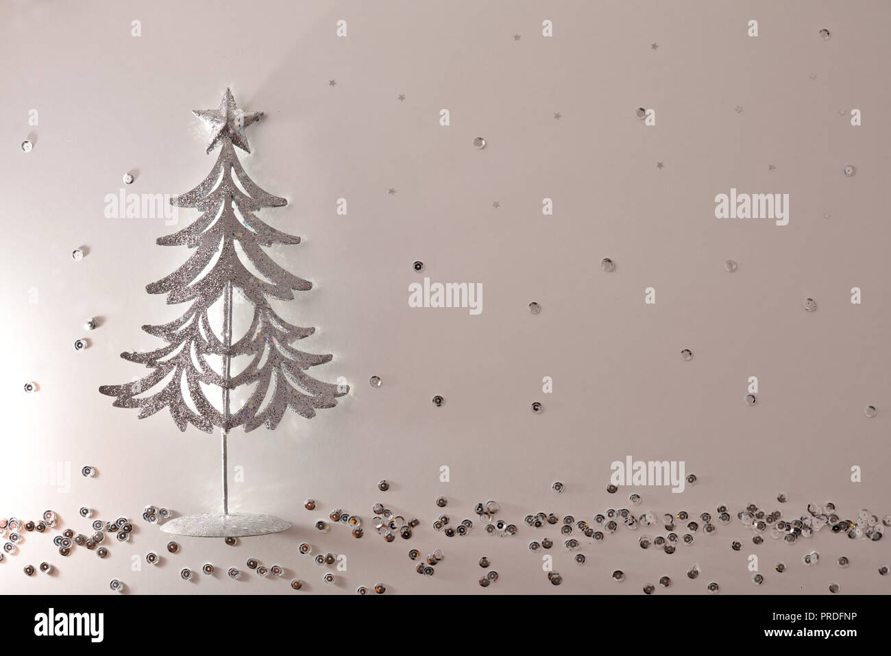 Christmas decoration silver tree with glitter and snow Stock Photo - Alamy