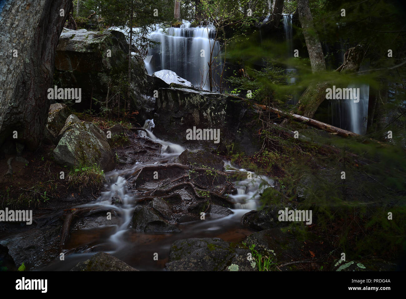 Springtime after the winter thaw with water pouring and flowing over ...