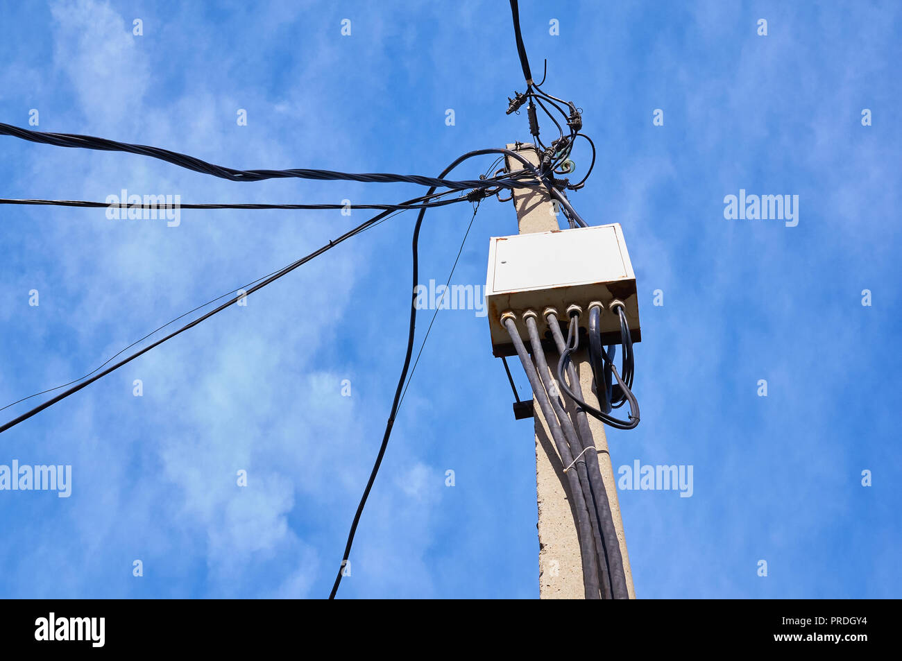 Concrete pillar with a power distribution box and wires Stock Photo - Alamy