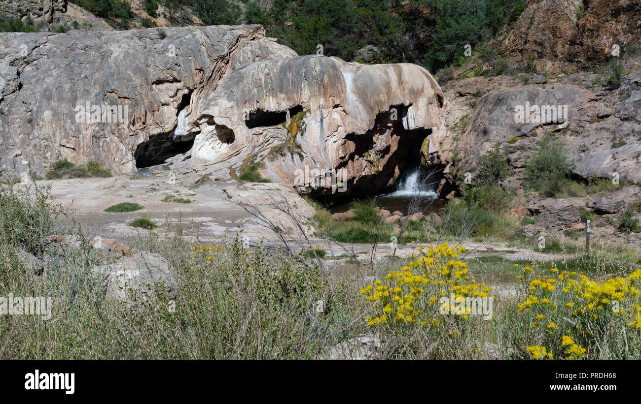 Desert oasis and waterfall coming out of a rock Stock Photo - Alamy