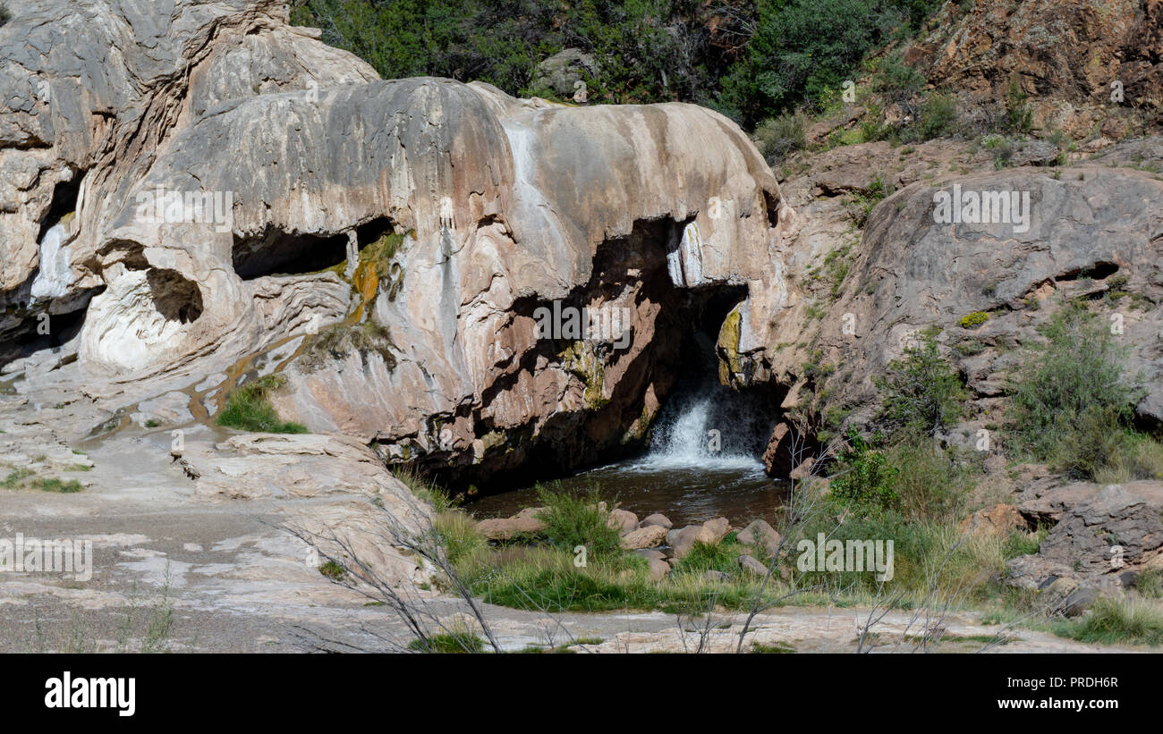 Desert oasis and waterfall coming out of a rock Stock Photo - Alamy
