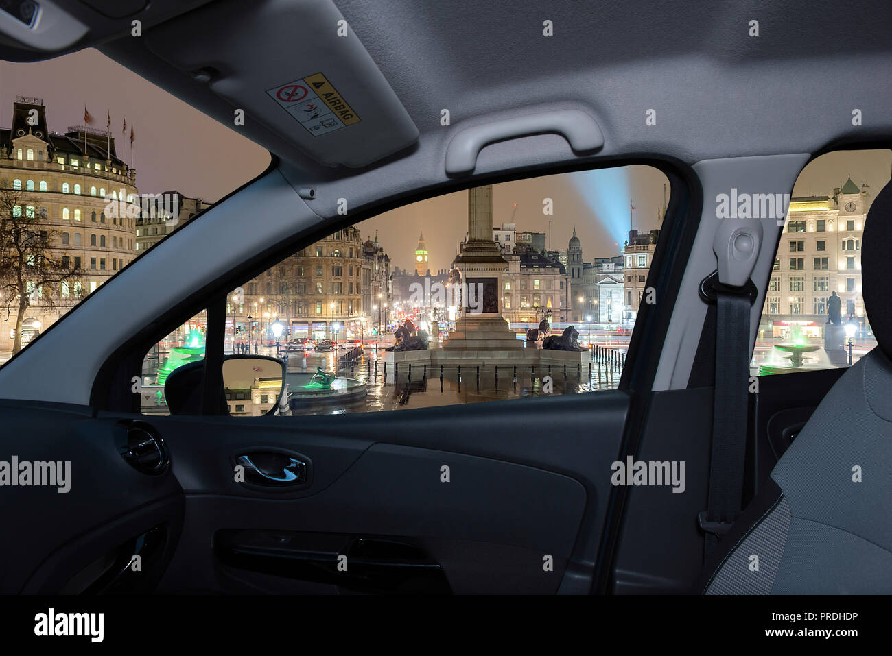 Looking through a car window with view of Trafalgar Square at night ...