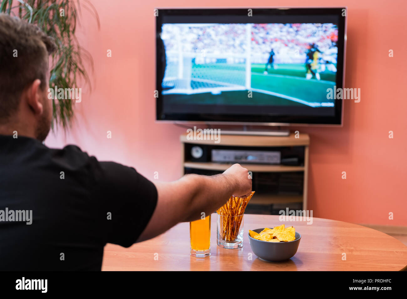 Football fan on sofa stadium hi-res stock photography and images - Alamy