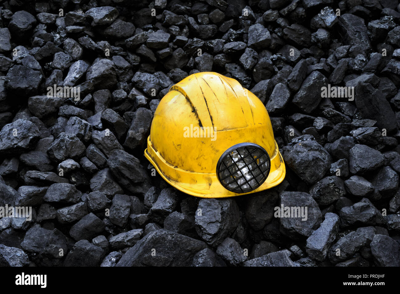 Yellow miners safety helmet on top of the coal mining Stock Photo - Alamy