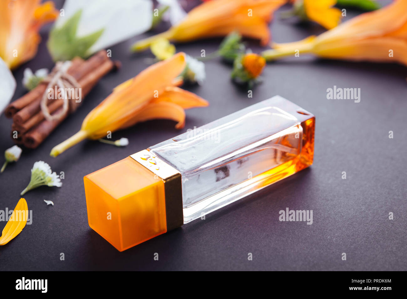 Bottle of perfume with ingredients on black background Stock Photo - Alamy