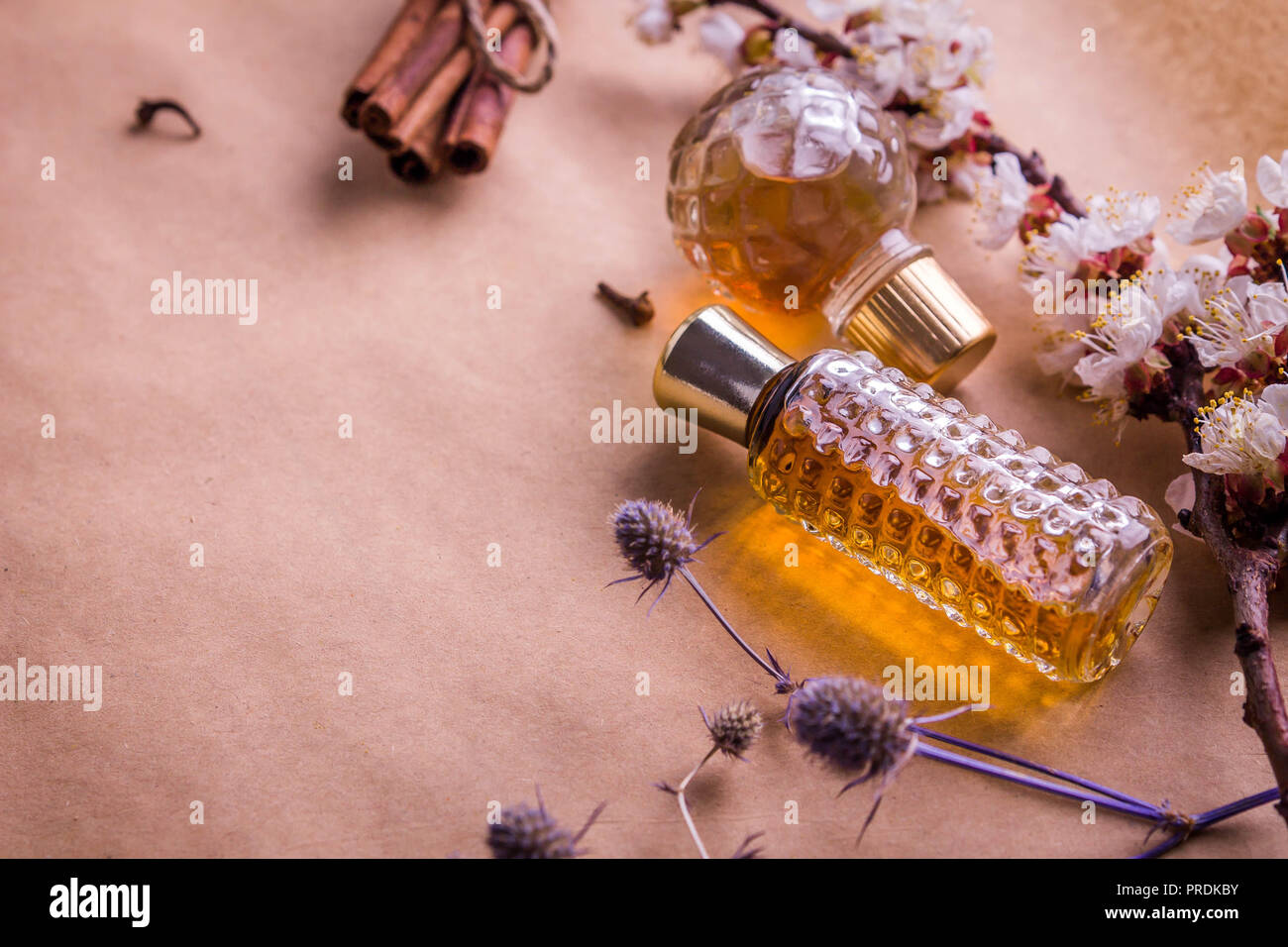 Bottles of perfume with ingredients on paper Stock Photo - Alamy