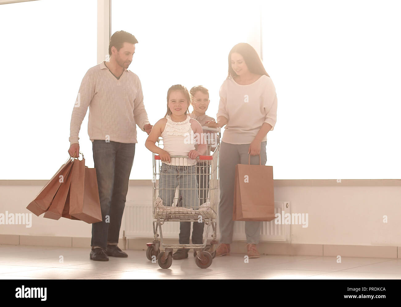 parents with children standing in the hypermarket Stock Photo - Alamy