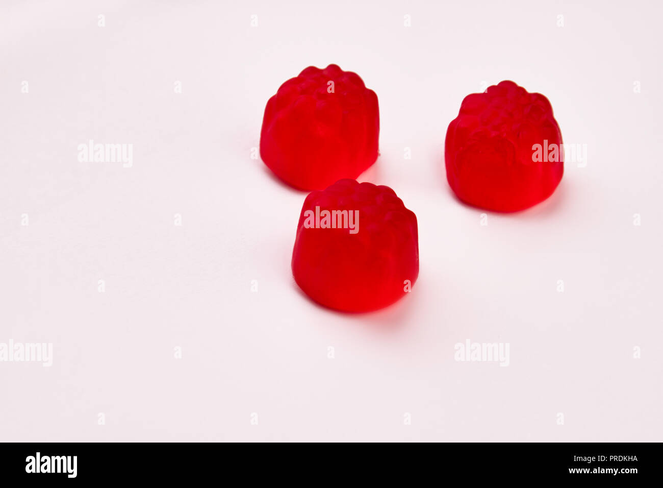 Red jelly candies on white background Stock Photo - Alamy