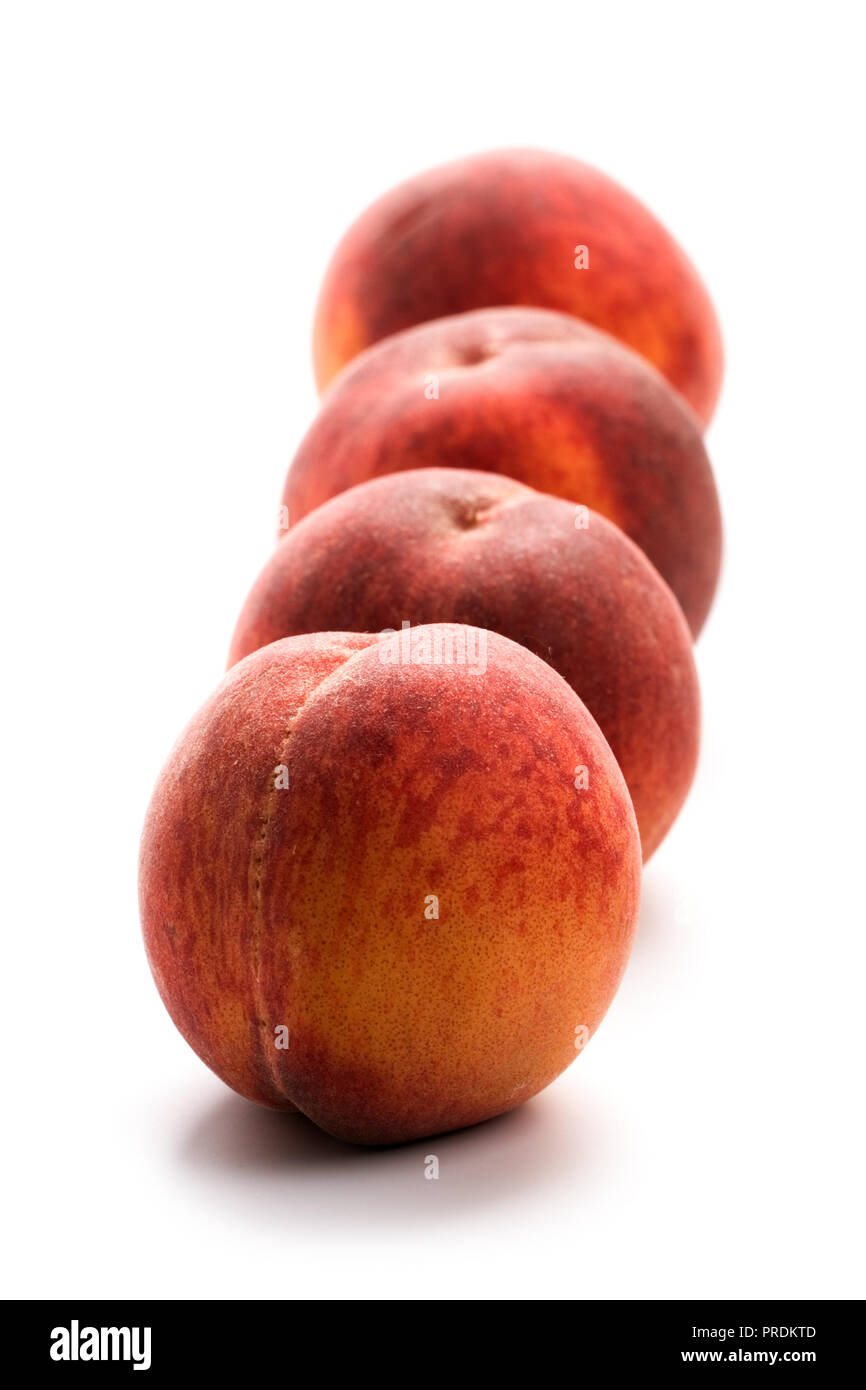 four peaches on white background Stock Photo - Alamy
