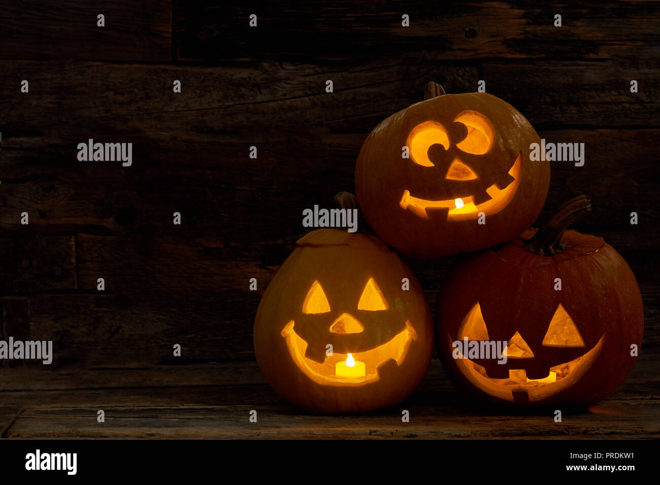 Three pumpkin Jack-O-Lantern with happy faces Stock Photo - Alamy