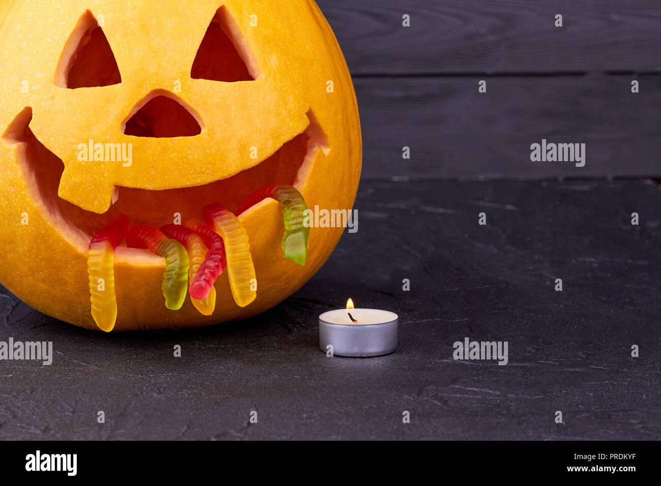 Halloween pumpkin with candle on dark background Stock Photo - Alamy