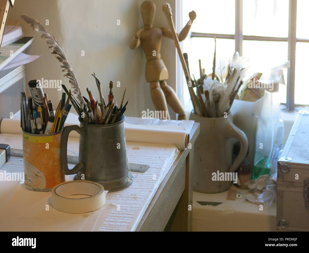 Atmospheric view of an attic window in an artist's studio with pots of ...