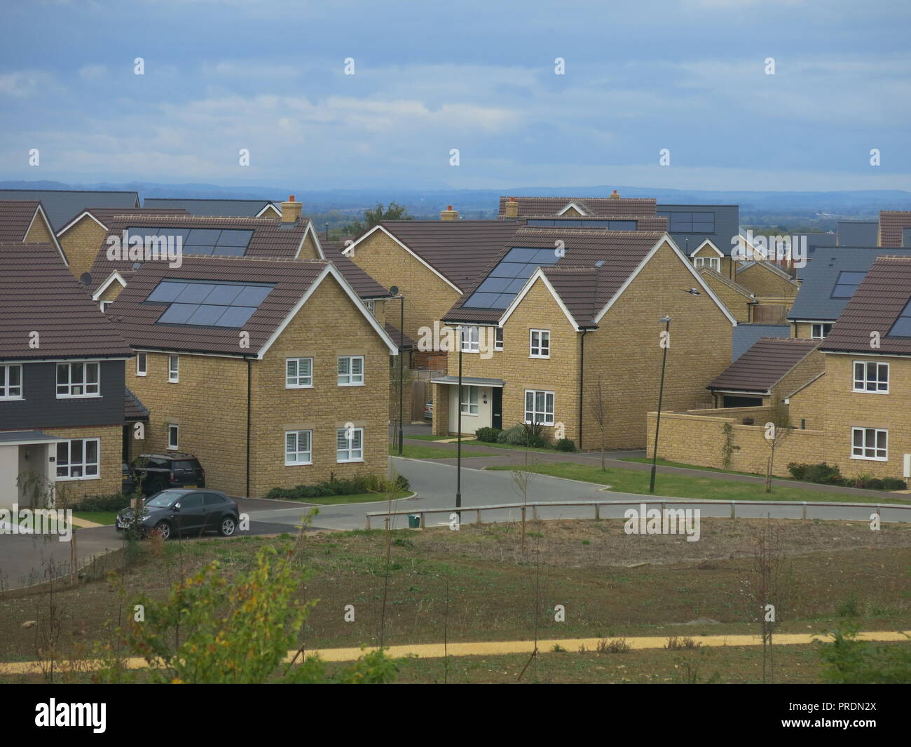 A view from the train window of a new housing development on green ...