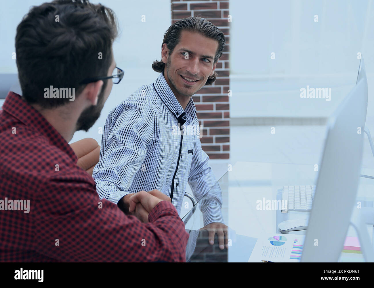 Two men handshake in the office Stock Photo - Alamy