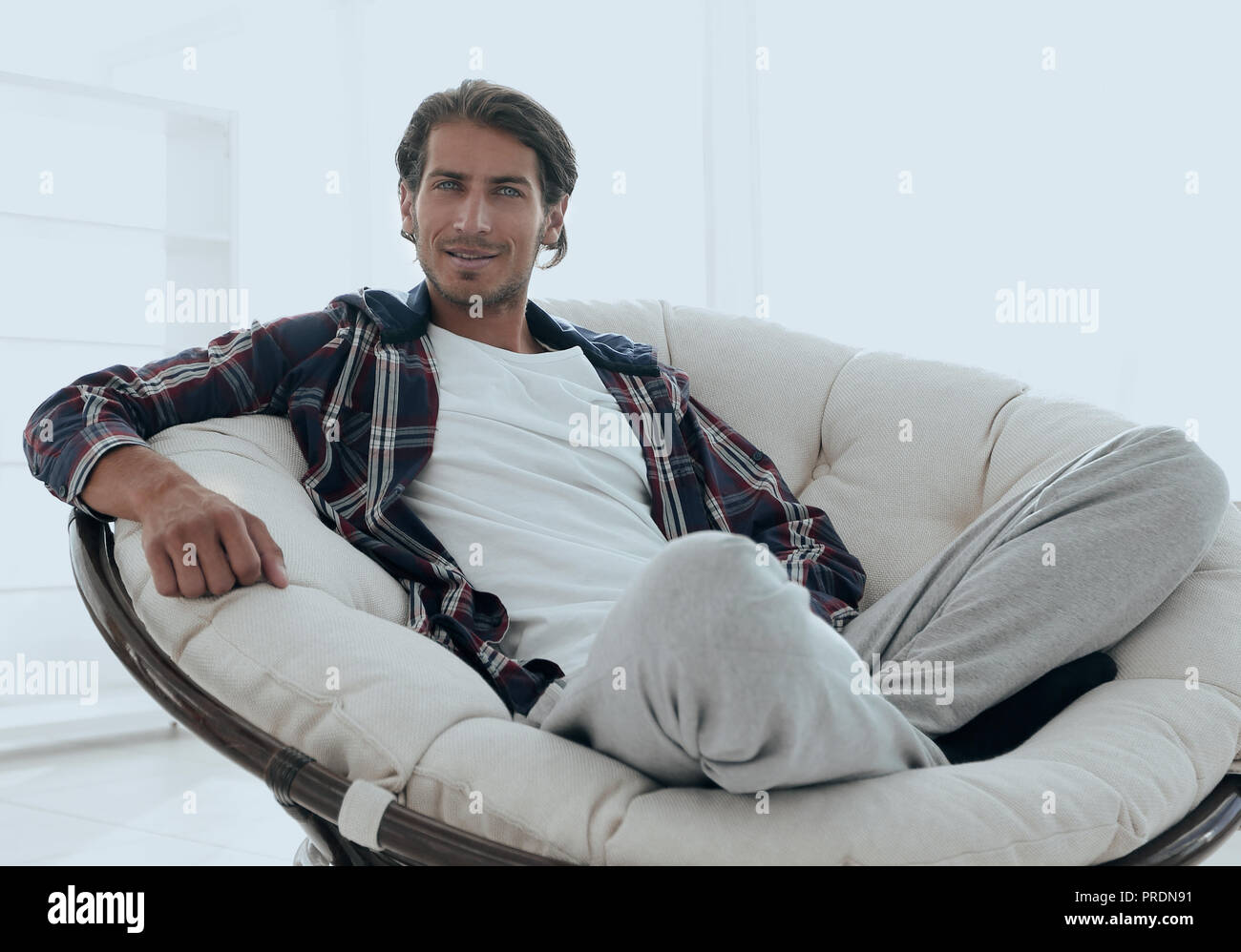successful guy resting in modern living room Stock Photo - Alamy