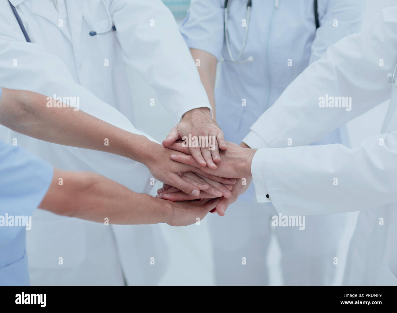 doctors holding hands together at hospital Stock Photo - Alamy