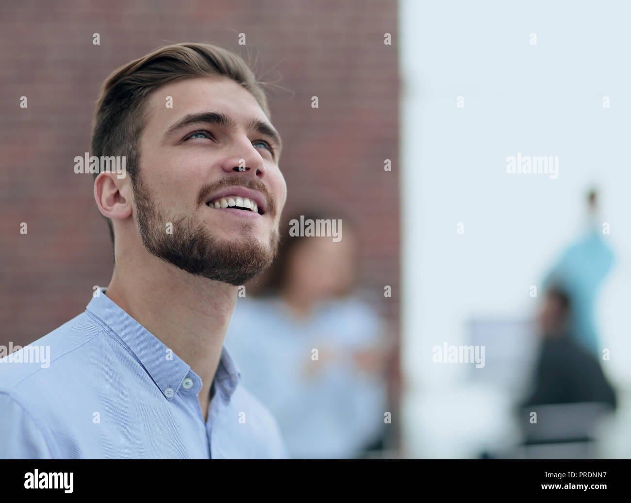 Smiling businessman in profile on office background Stock Photo - Alamy