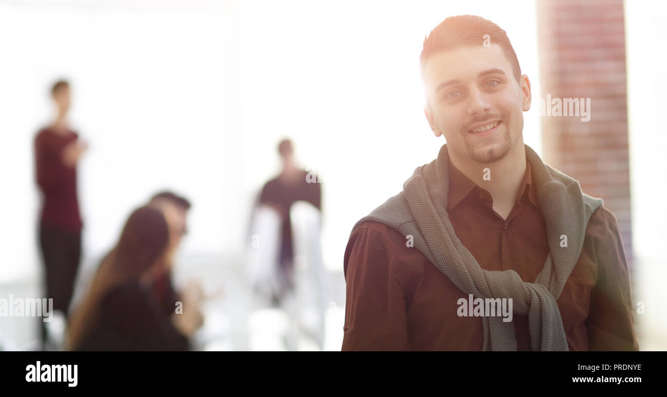 confident young man in the background of the office. photo with copy ...