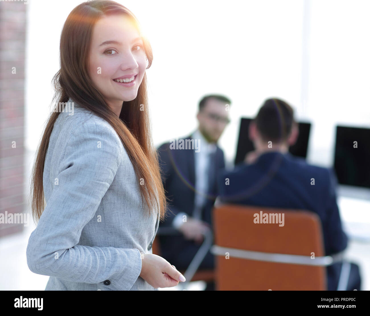 smiling employee on the background of the office.photo with copy spa ...