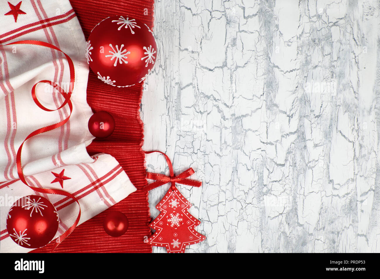 Christmas background with napkin, red baubles, ribbon and a candy cane ...