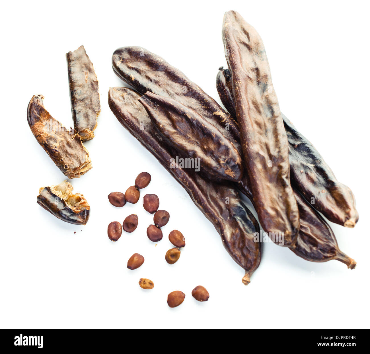 Organic carob pods with seeds on white background Stock Photo - Alamy