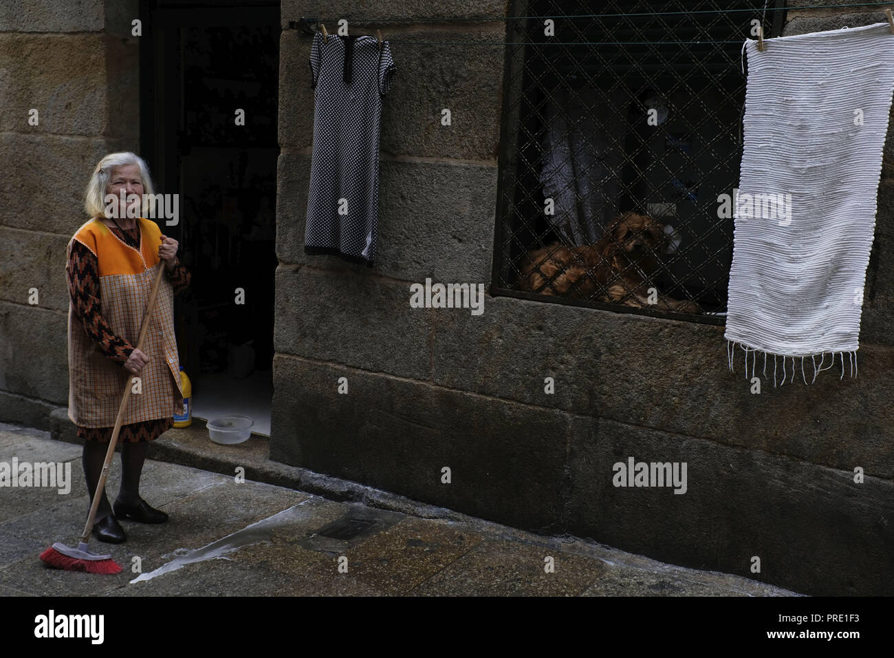 Vigo, Spain. 14th May, 2018. A local woman of Vigo Spain washes the ...
