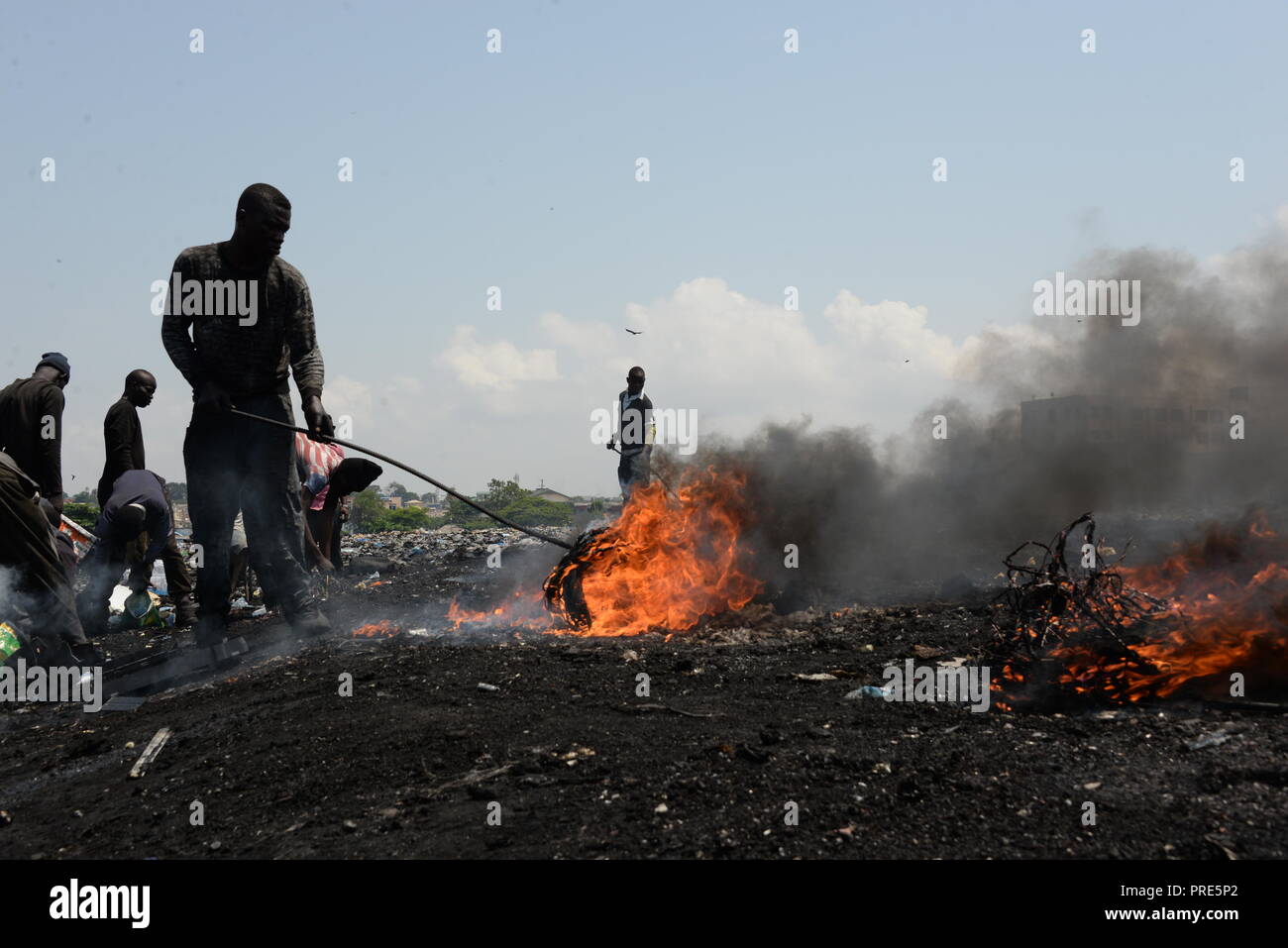 Accra, Ghana. 12th June, 2018. At the Agbogbloshie scrap yard, men burn ...