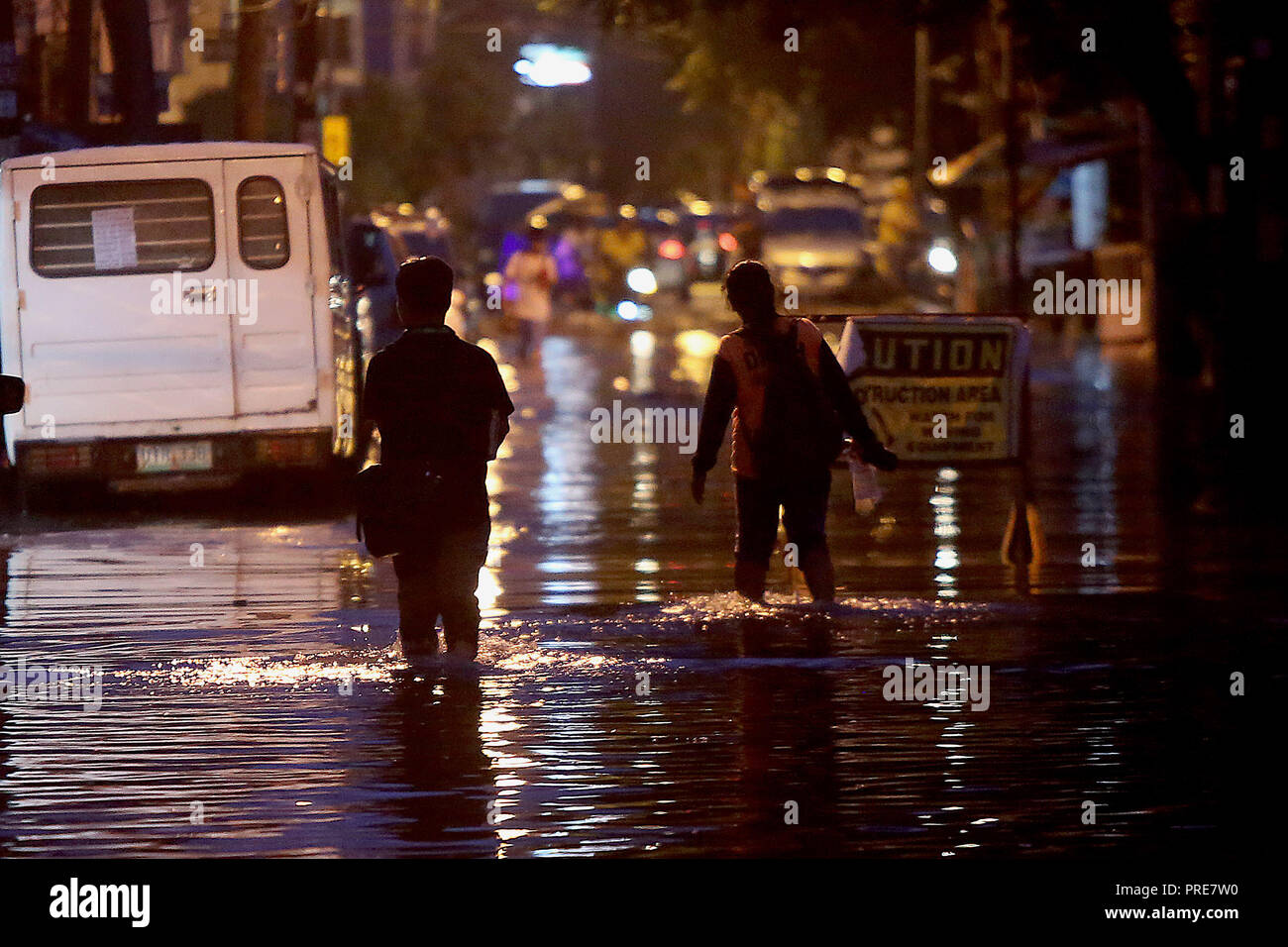 Makati City, Philippines. 2nd Oct, 2018. People wade through a flooded ...