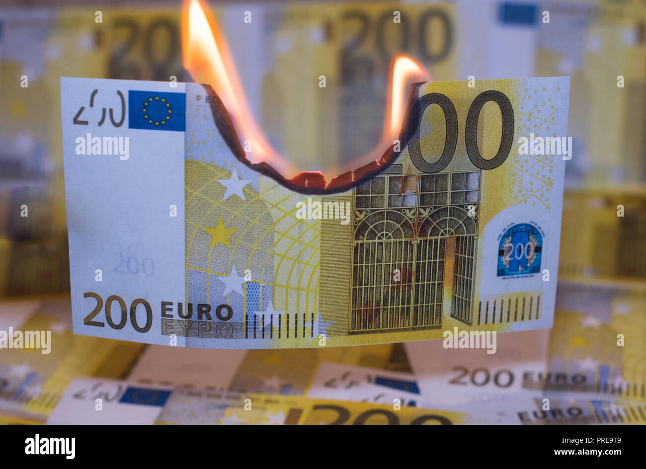 Two hundred euro bill in Europe currency is on fire Stock Photo - Alamy