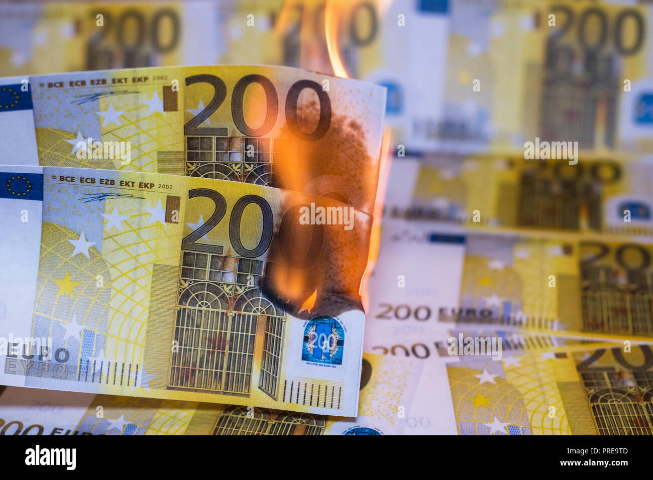 Two hundred euro bill in Europe currency is on fire Stock Photo - Alamy