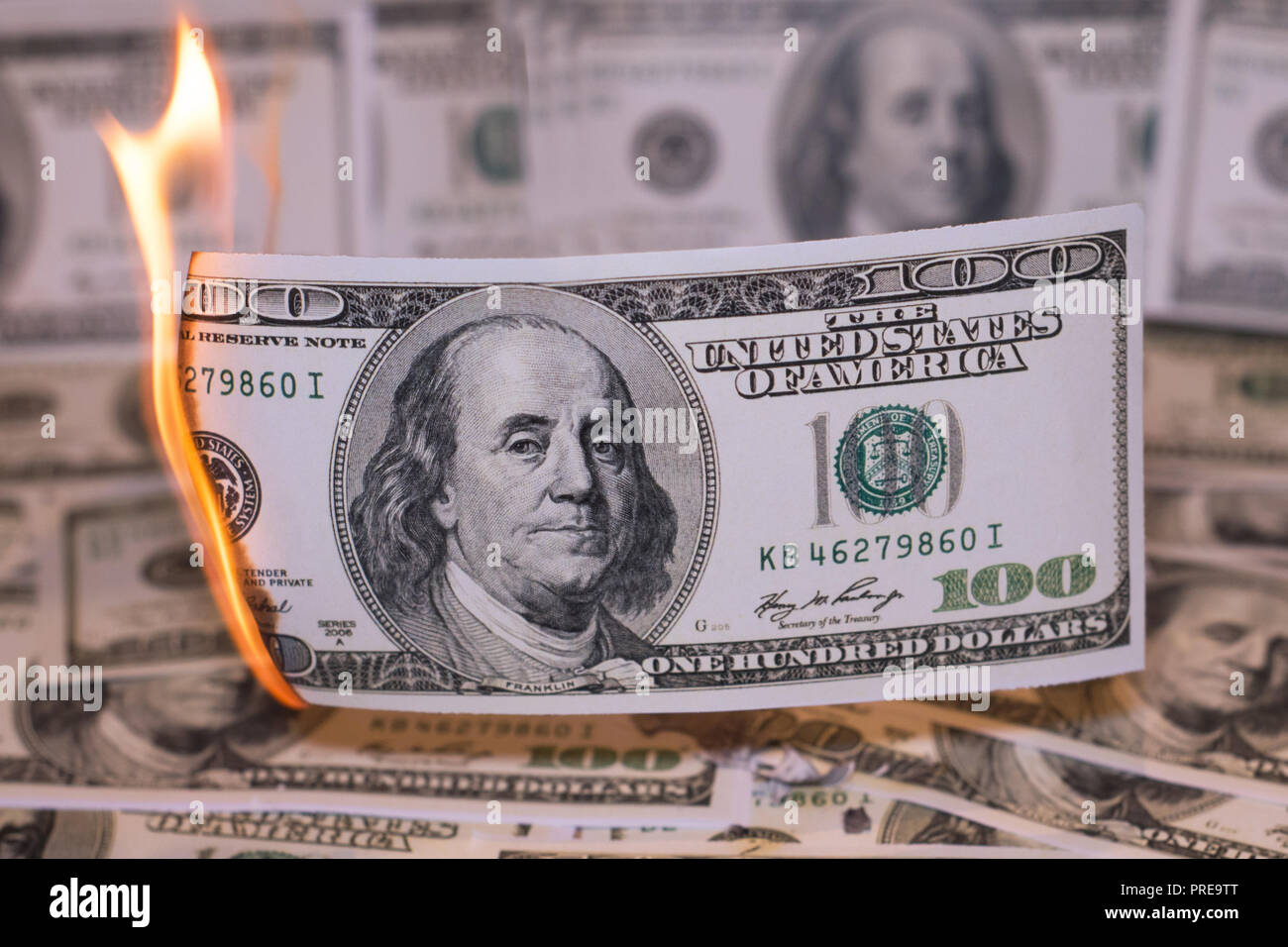 A hunred dollar bill in American US currency is on fire Stock Photo - Alamy