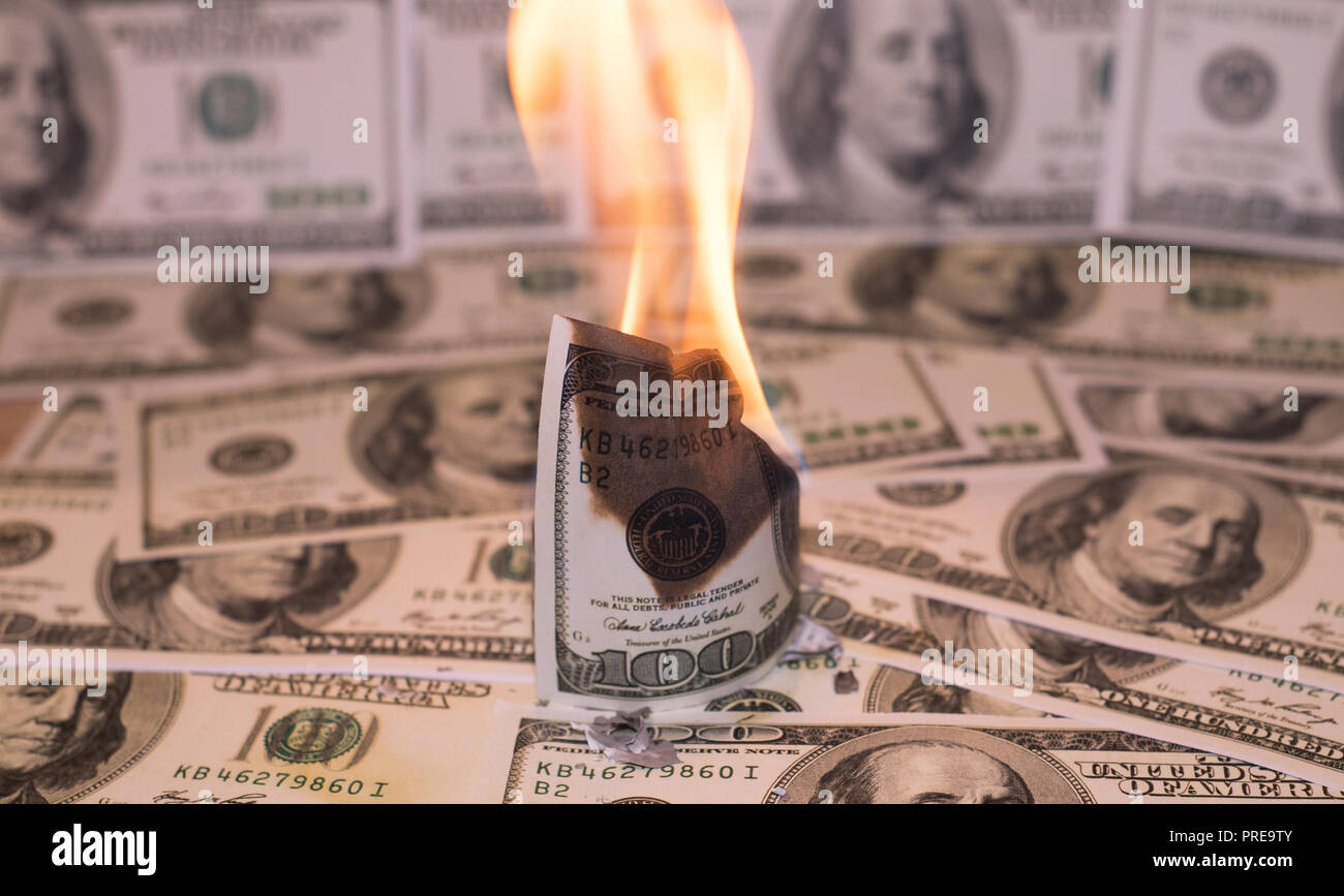 A hunred dollar bill in American US currency is on fire Stock Photo - Alamy