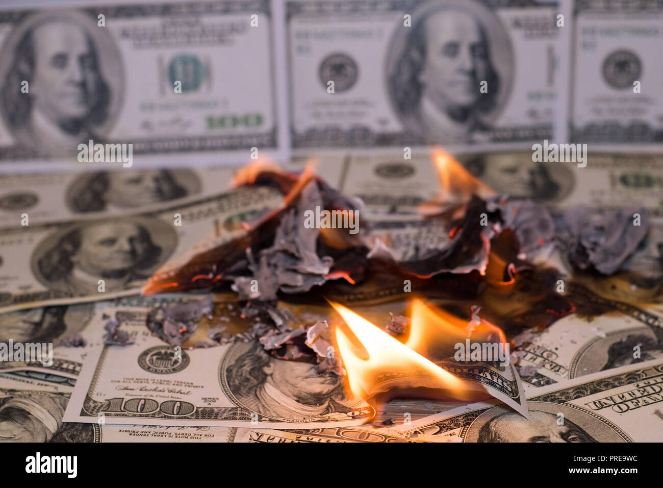 A hunred dollar bill in American US currency is on fire Stock Photo - Alamy
