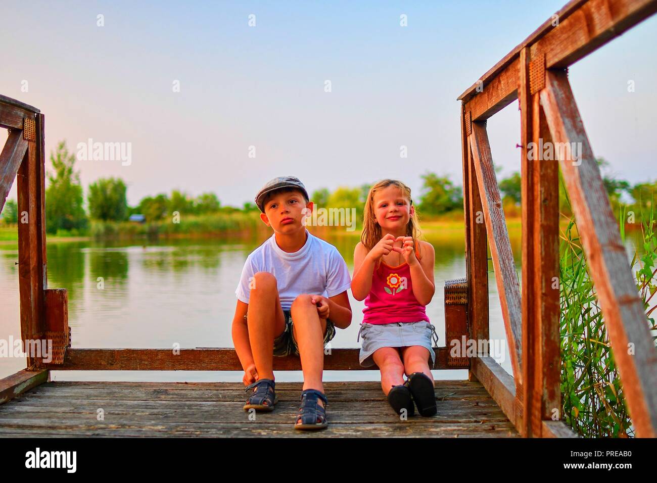Children sitting on pier hi-res stock photography and images - Alamy