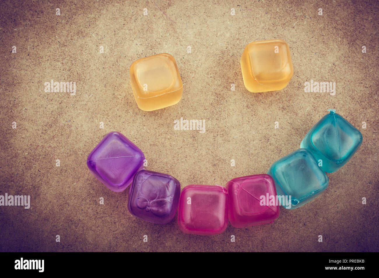 Fake colorful ice cubes on a brown background Stock Photo - Alamy