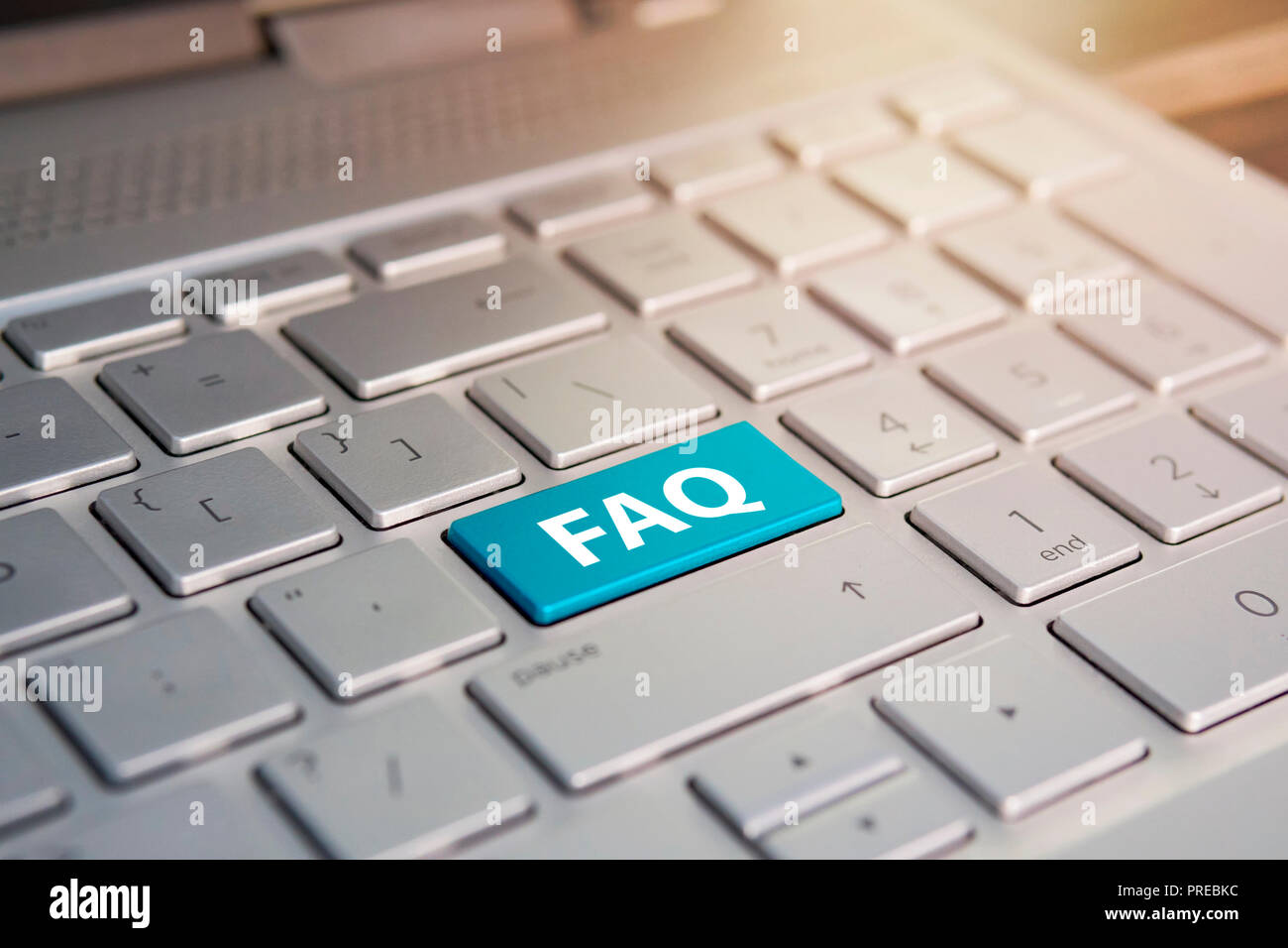 Keyboard with faq button . blue Color button on the gray silver ...