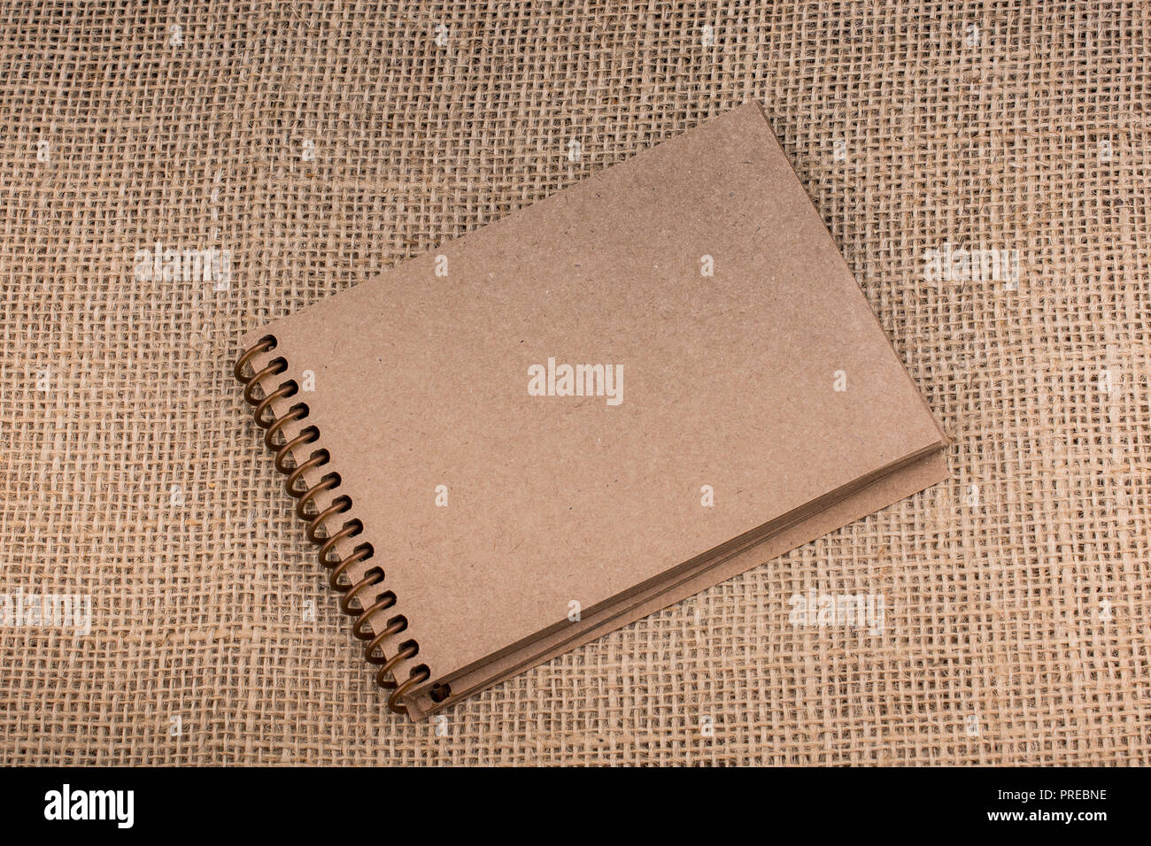 brown color notebook placed on a canvas background Stock Photo - Alamy
