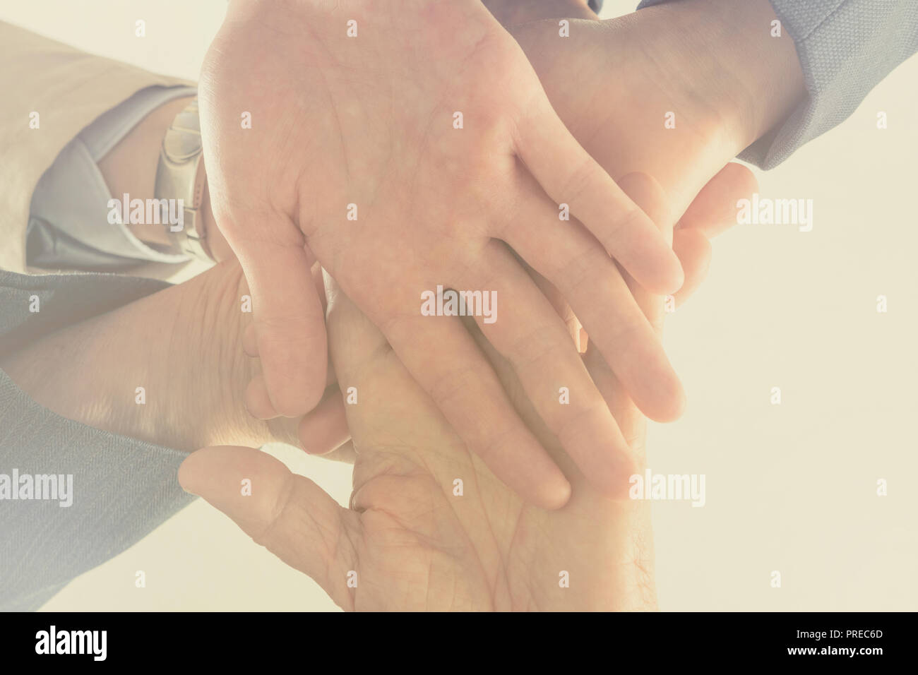 Close up bottom view business people putting their hands together. Arms ...