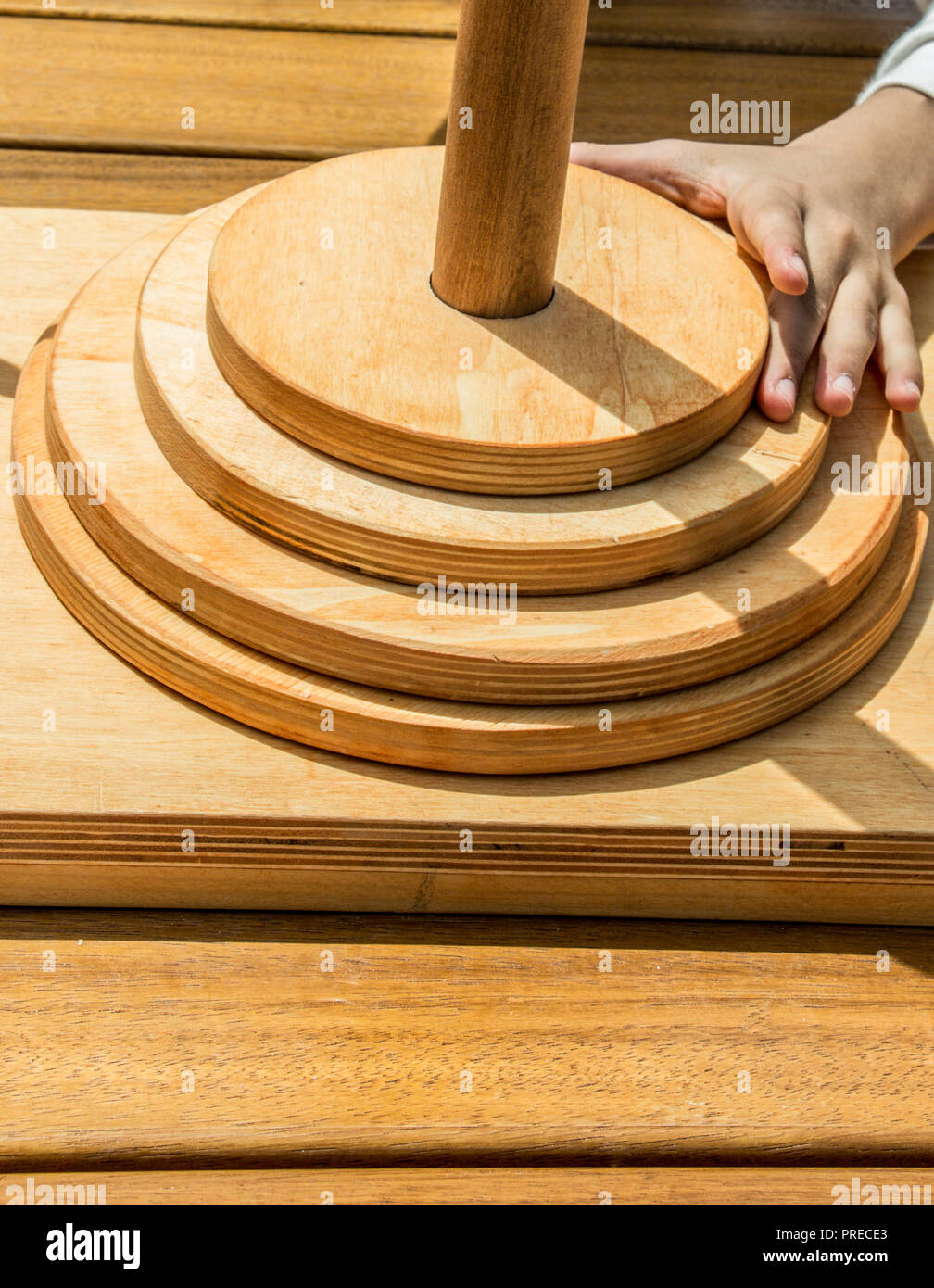 Hand holding wooden puzzle element in hand Stock Photo - Alamy