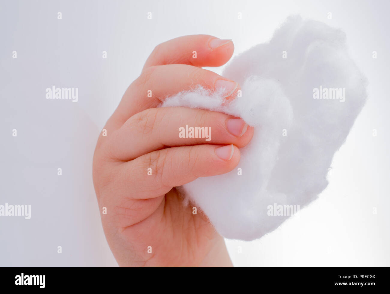 Hand holding some cotton in hand on a white background Stock Photo - Alamy