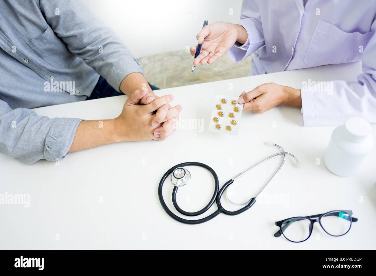 doctor hand holding tablet of drug and explain to patient in hospital ...