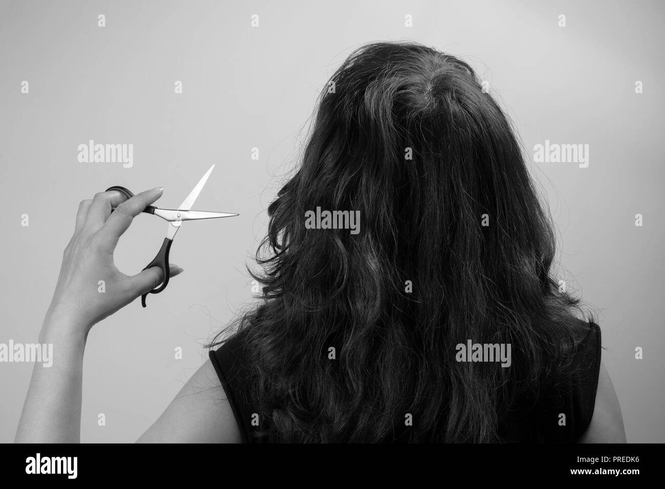 Angry young woman cutting hair hi-res stock photography and images - Alamy