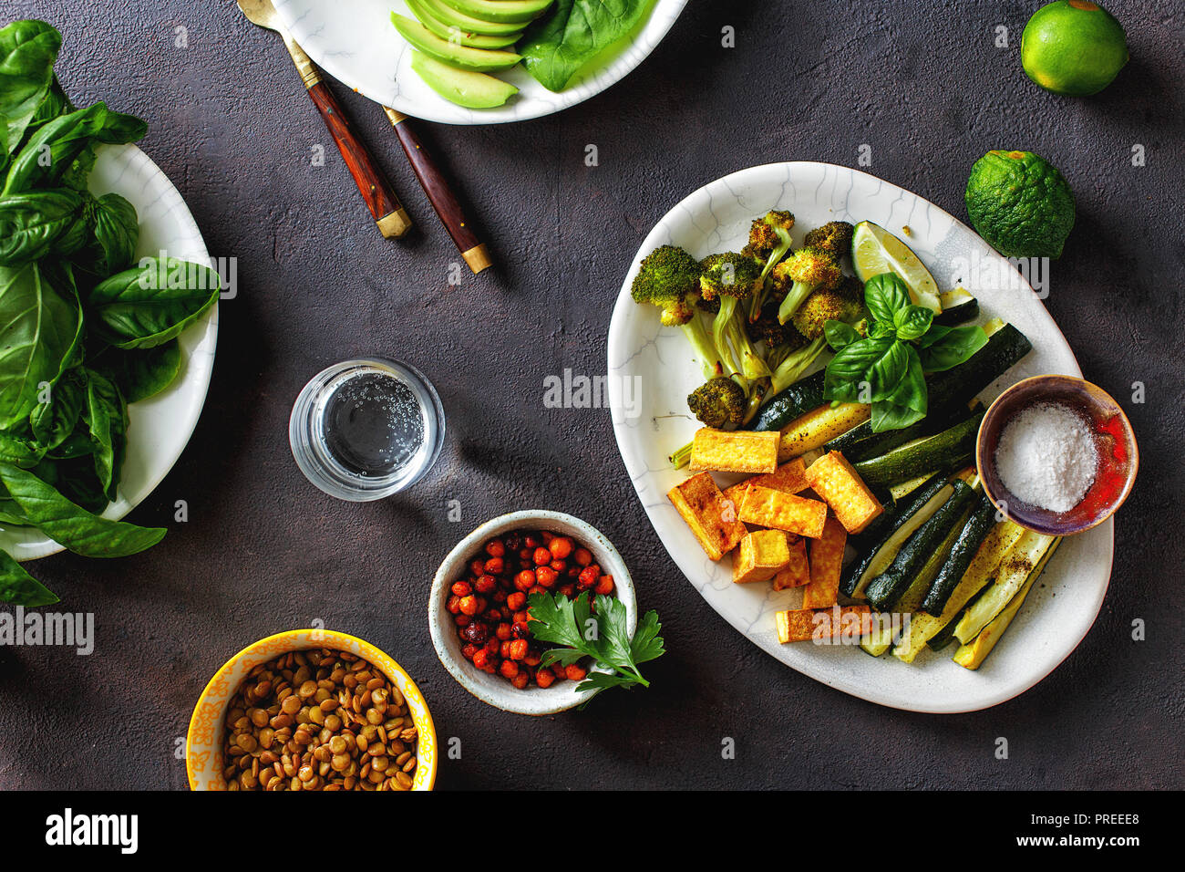 Healthy dinner table concept. Fried vegetables with tofu cheese and ...